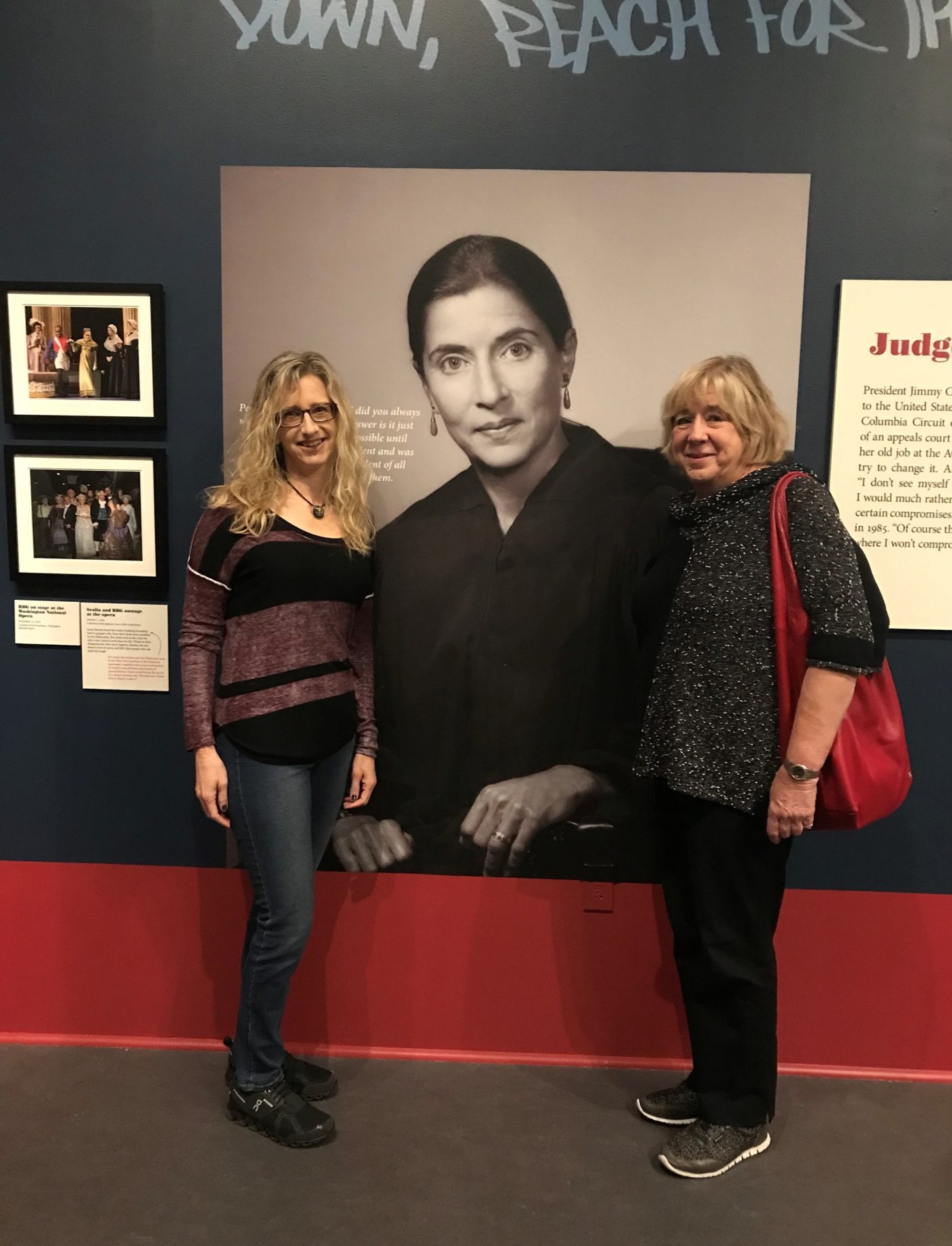 Standing in front of a photograph of the young Ruth Bader Ginsburg are ...